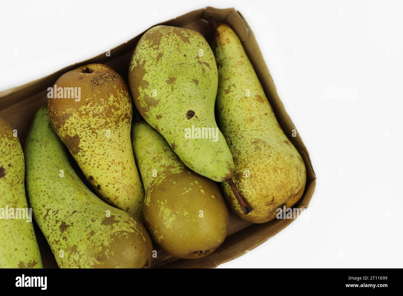 Pile of green ripe pears Conference packaged in rectangle carton ...
