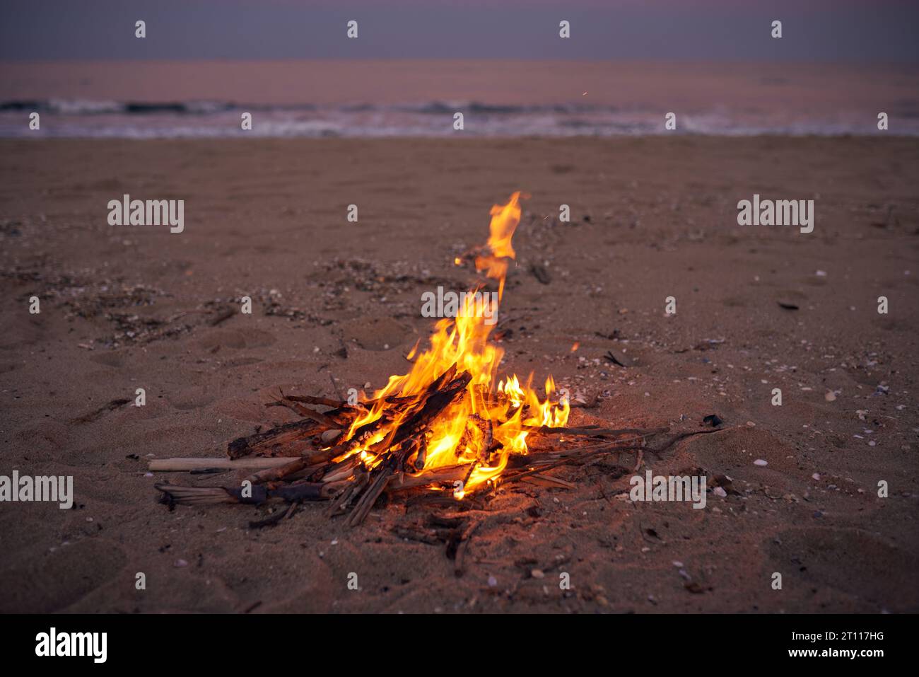 Beach campfire with Beautiful Sunset or sunrise Stock Photo - Alamy