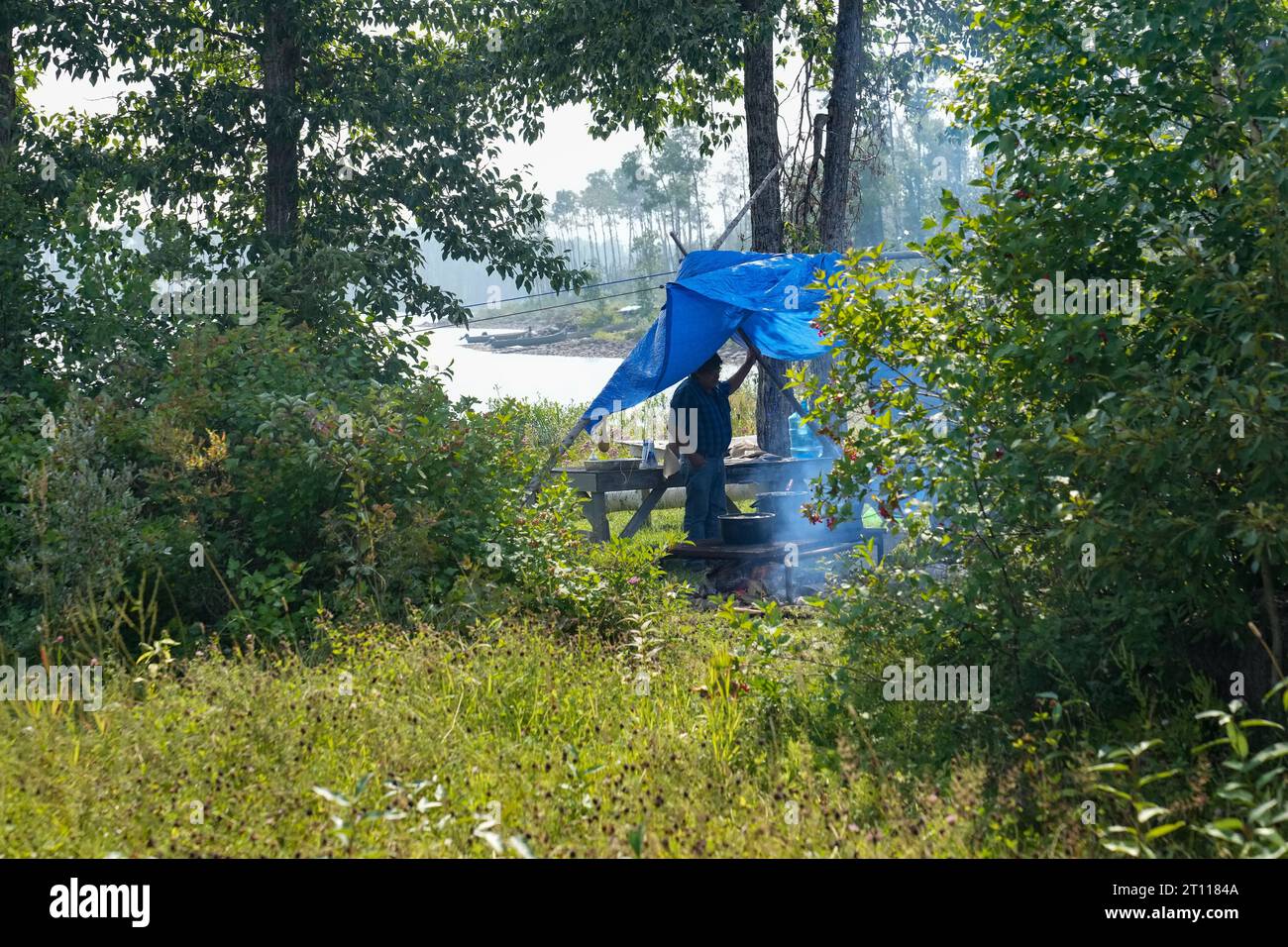 Neskantaga, Can. 18th Aug, 2023. A man cooks sturgeon in Neskantaga ...