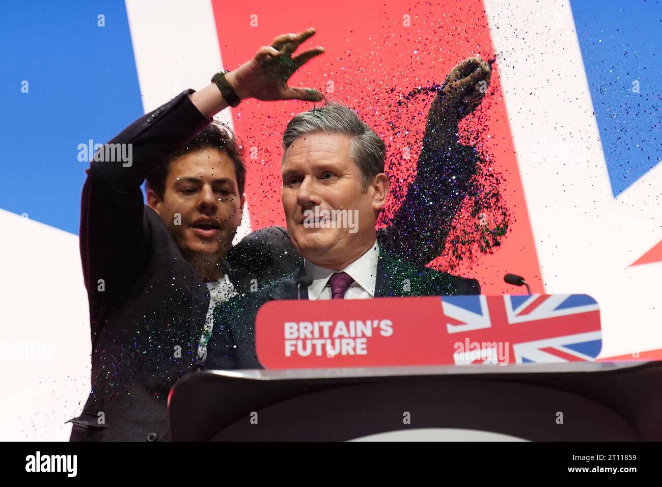 A protester throws glitter over and disrupts Labour leader Sir Keir ...