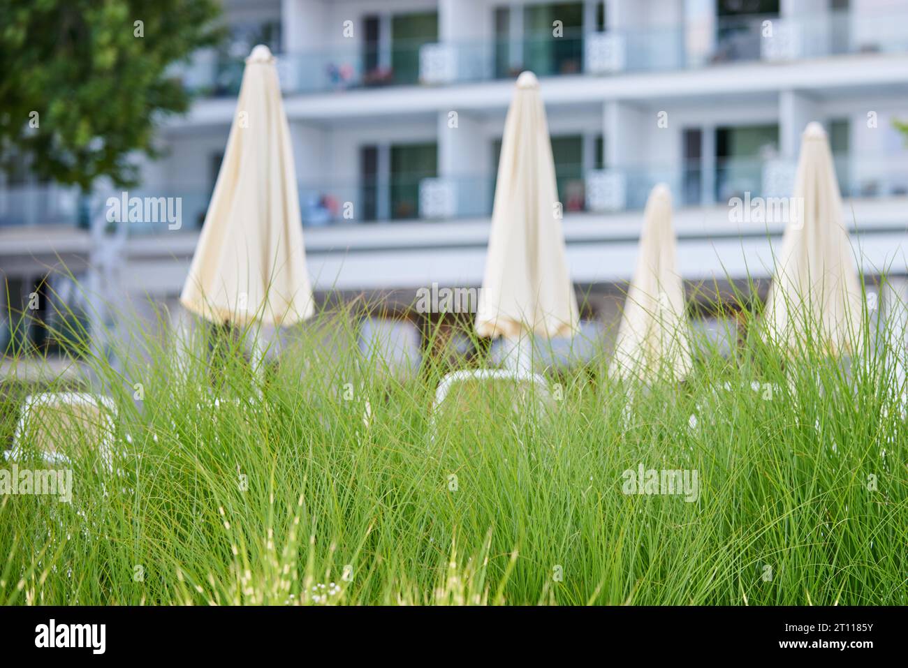 White building hotel with many terraces and green garden on a ...