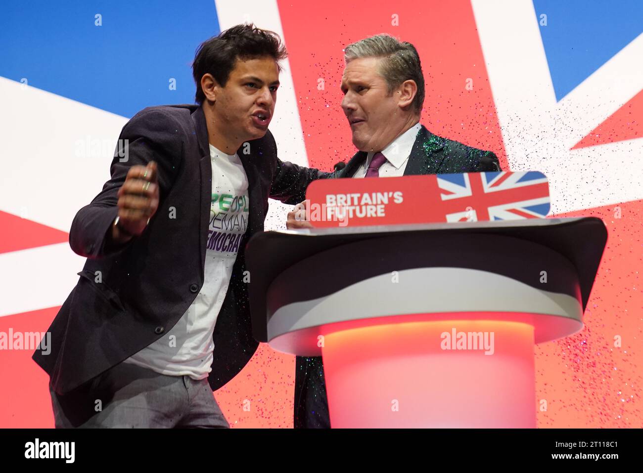 A protester throws glitter over and disrupts Labour leader Sir Keir ...