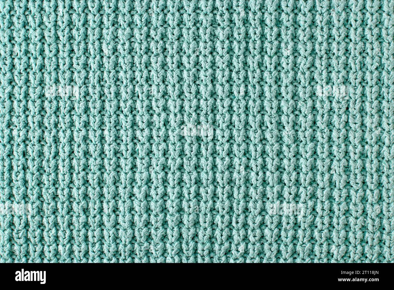 Texture of a rough knitted sweater close-up. Turquoise knitted backdrop ...