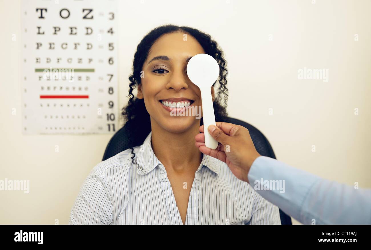 Woman, eye exam and occluder with optometrist test, check and lens for ...