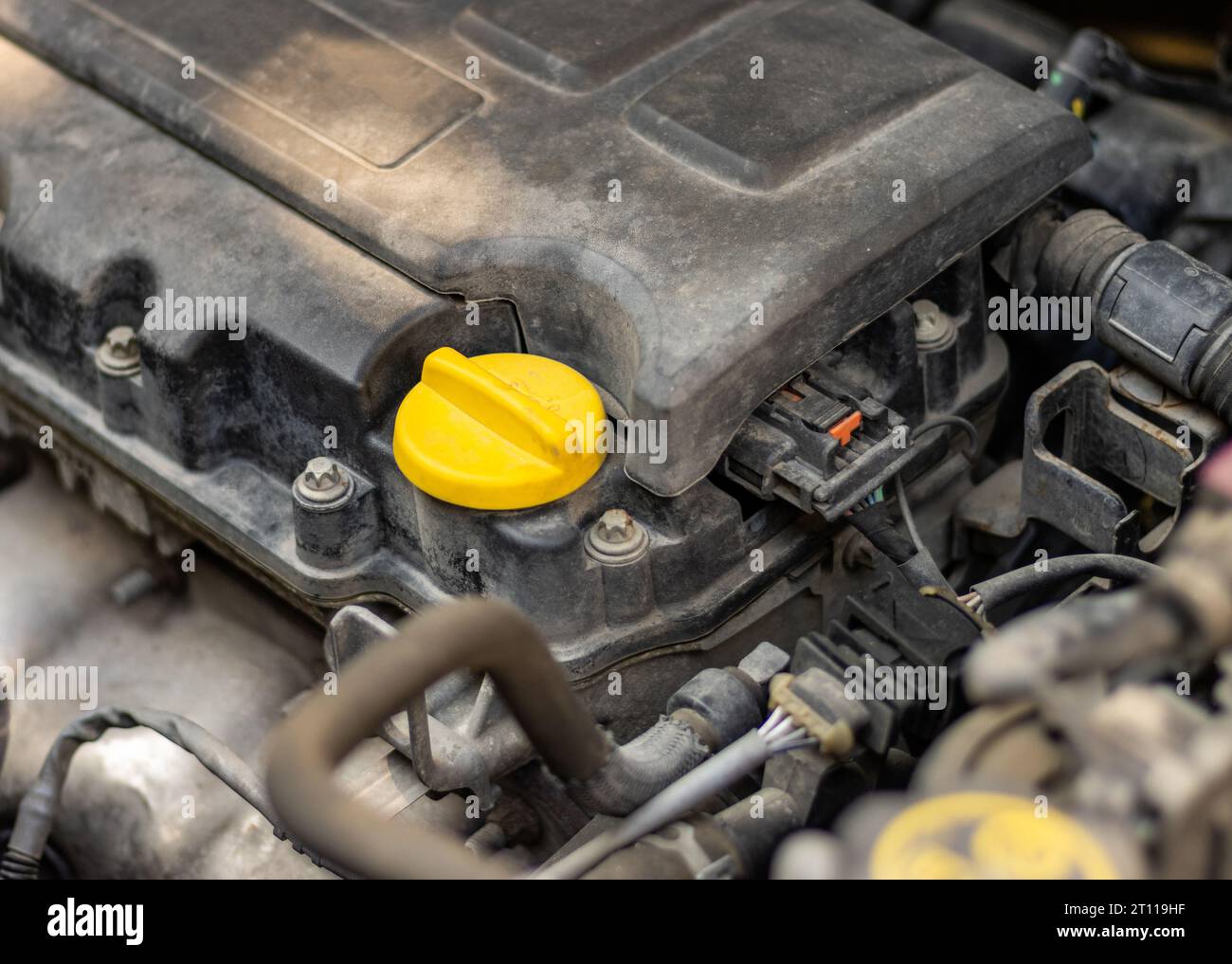 Car engine oil cap. Yellow color Stock Photo - Alamy