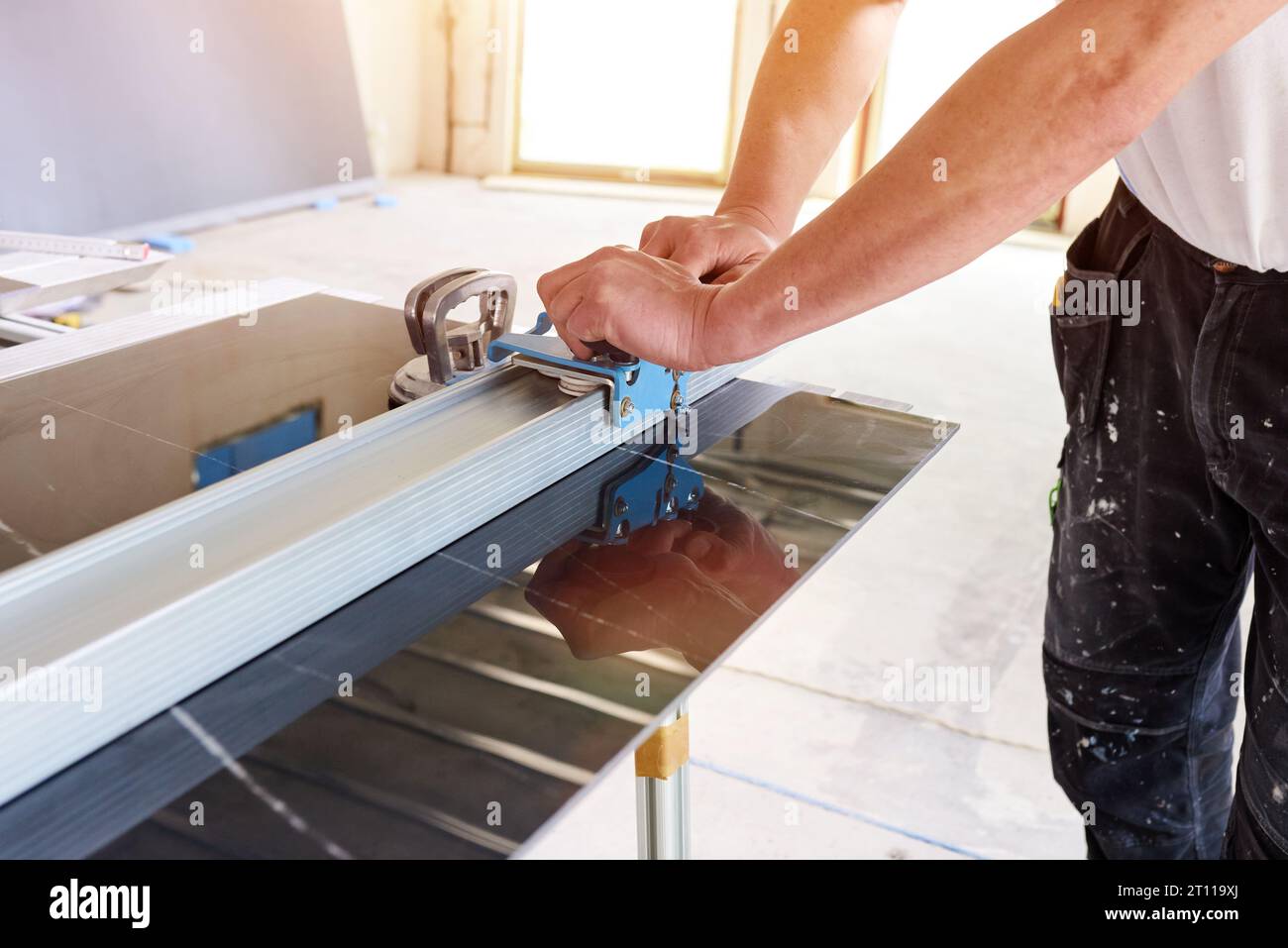 Construction Worker Cutting Ceramic Tiles Using Ceramic Cutter Stock