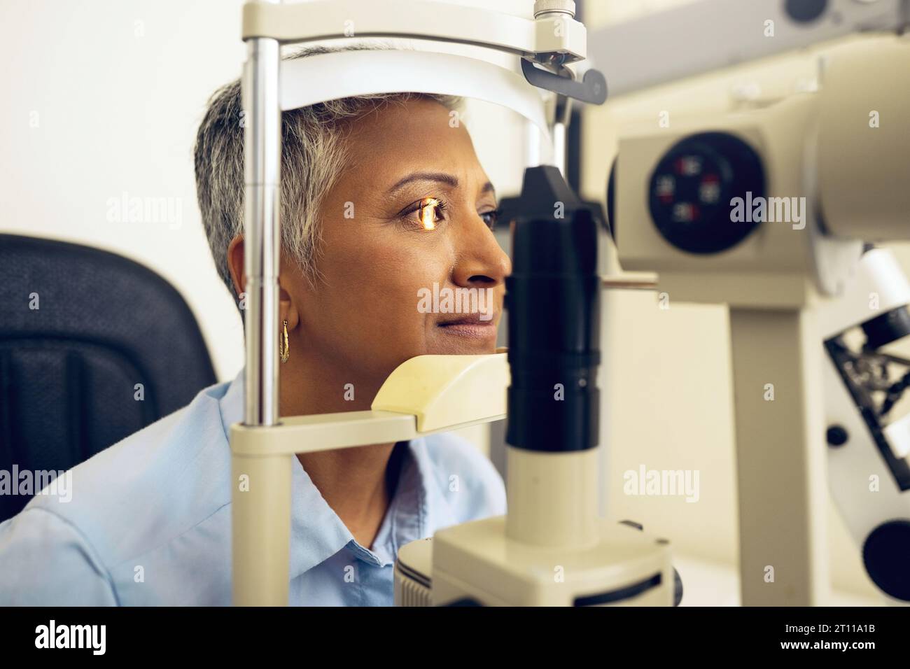 Senior woman, eye exam with vision and laser machine, health and vision ...
