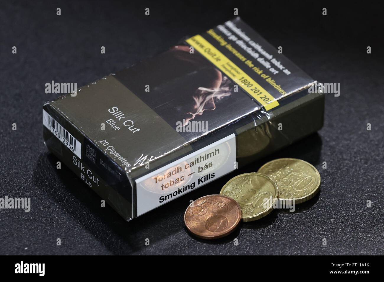 A packet of cigarettes photographed next to 75 cents. Minister for ...
