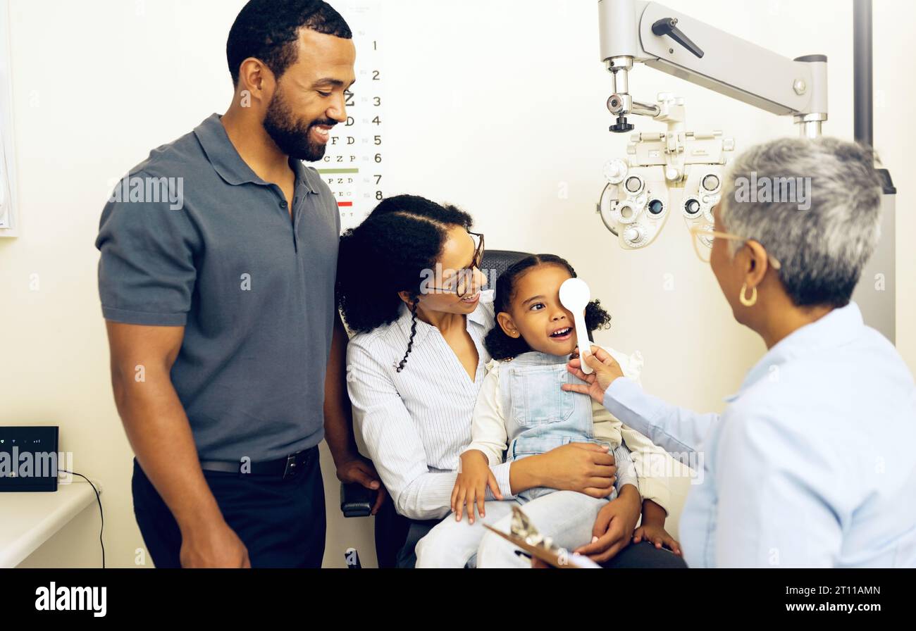 Family, optometry and eye exam with a woman doctor in a clinic to see a ...