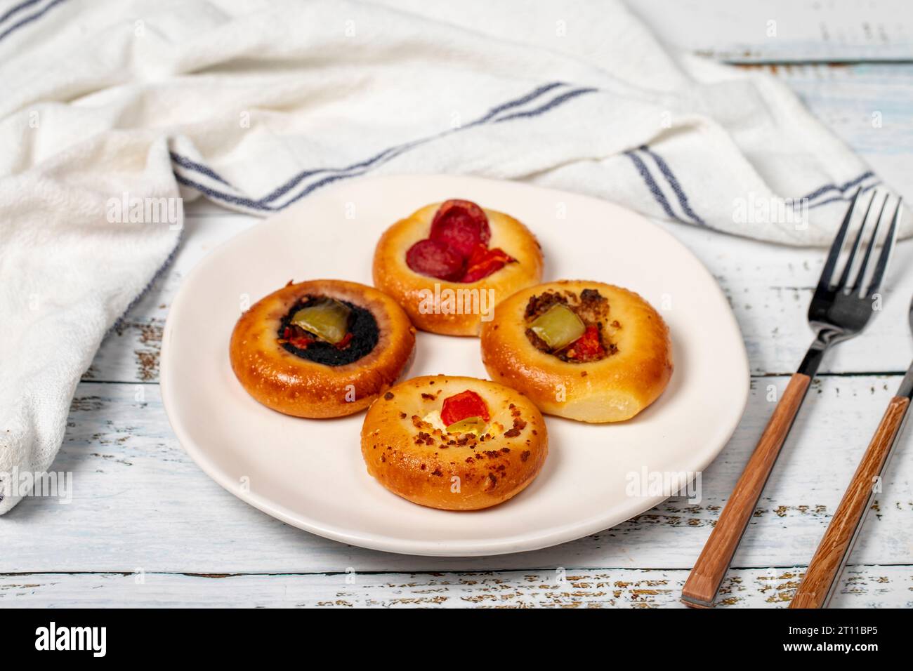 Small pizza varieties. mini pizzas with sausage, pickles, tomatoes ...