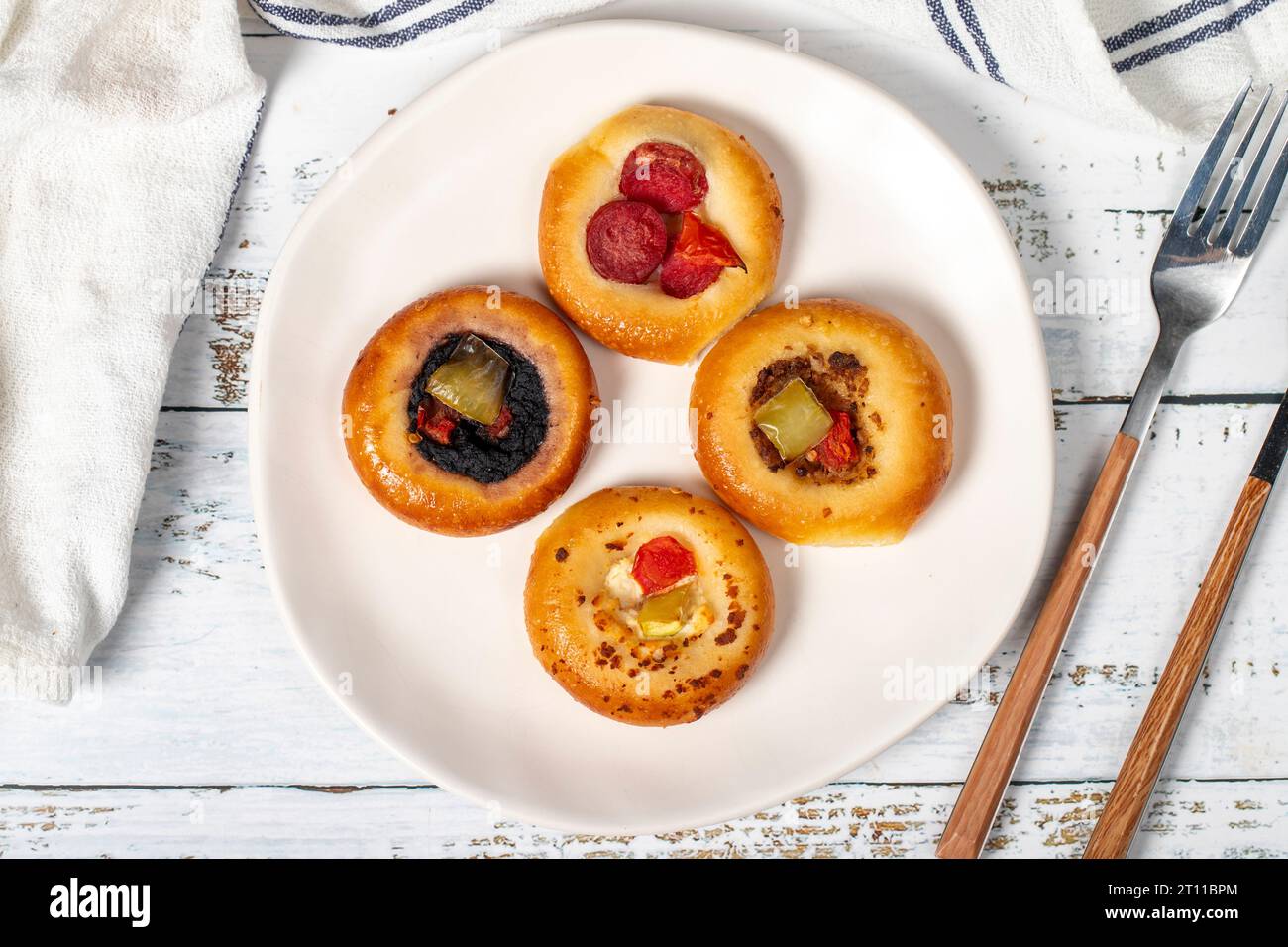 Small pizza varieties. mini pizzas with sausage, pickles, tomatoes ...