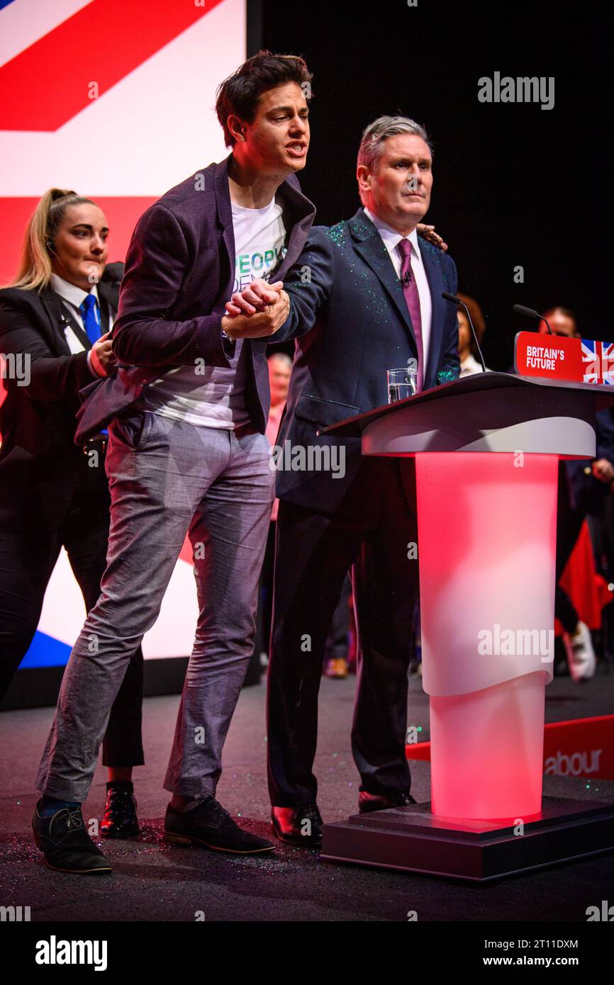 London, UK. 10 October 2023. A protester throws glitter over Labour ...