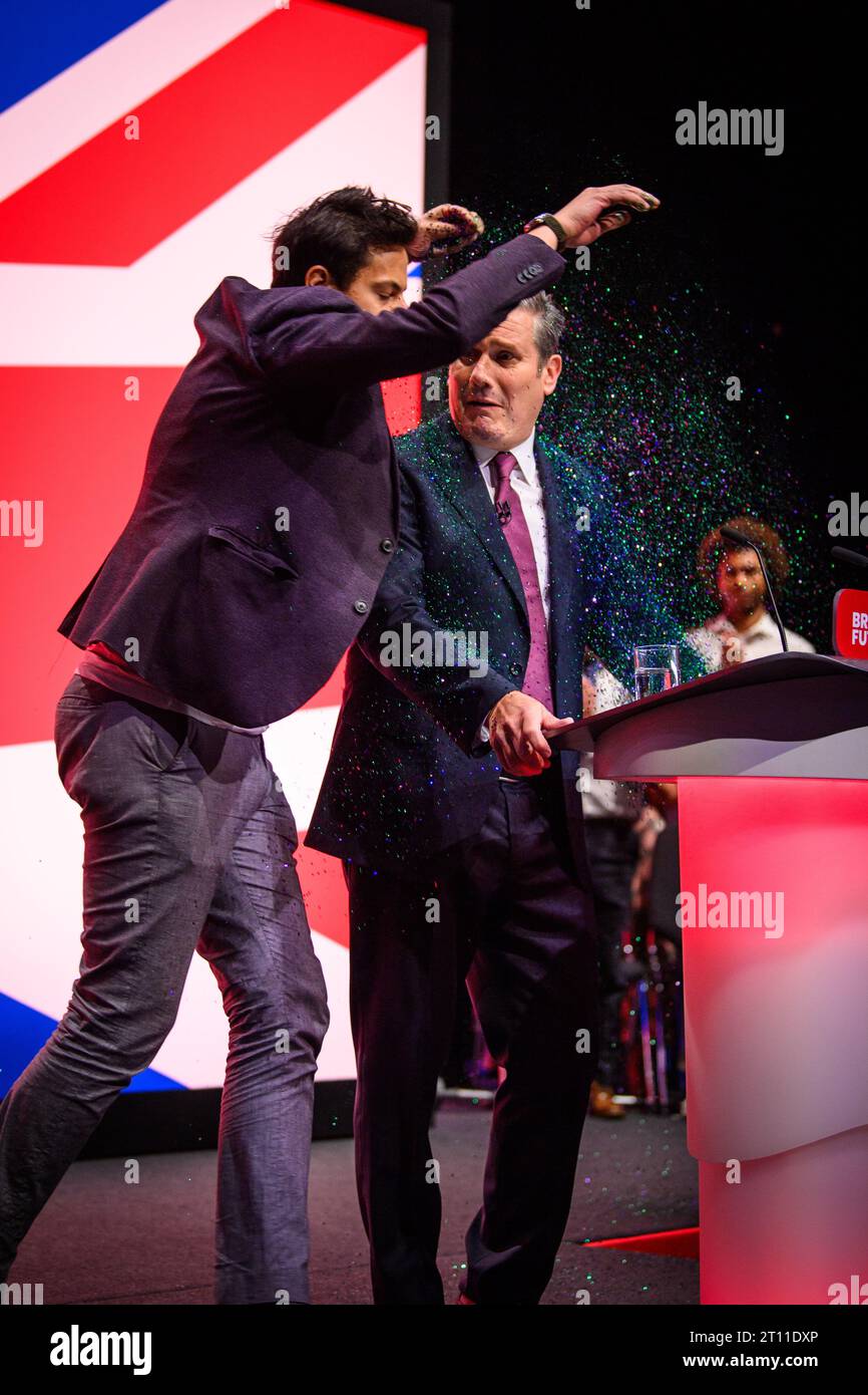 London, UK. 10 October 2023. A protester throws glitter over Labour ...