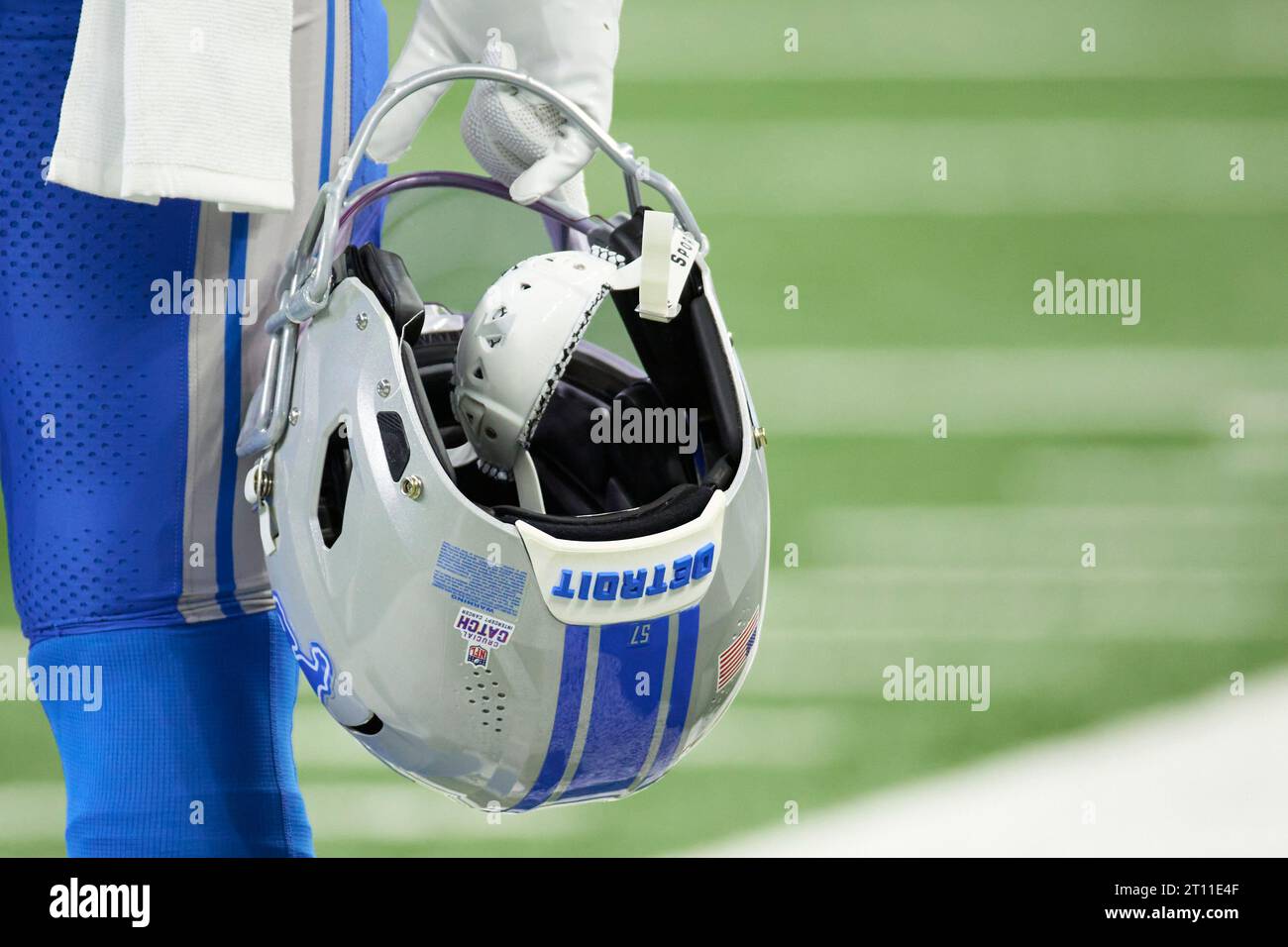 Detroit Lions linebacker Anthony Pittman (57) holds his helmet on the ...