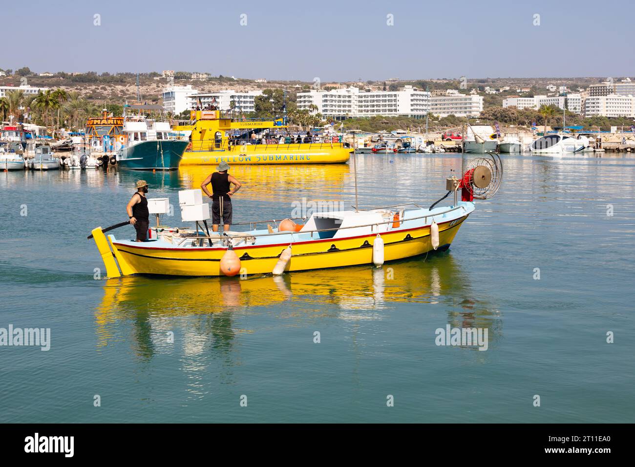 Fishermen set out from Ayia Napa Harbour in a bright yellow ...