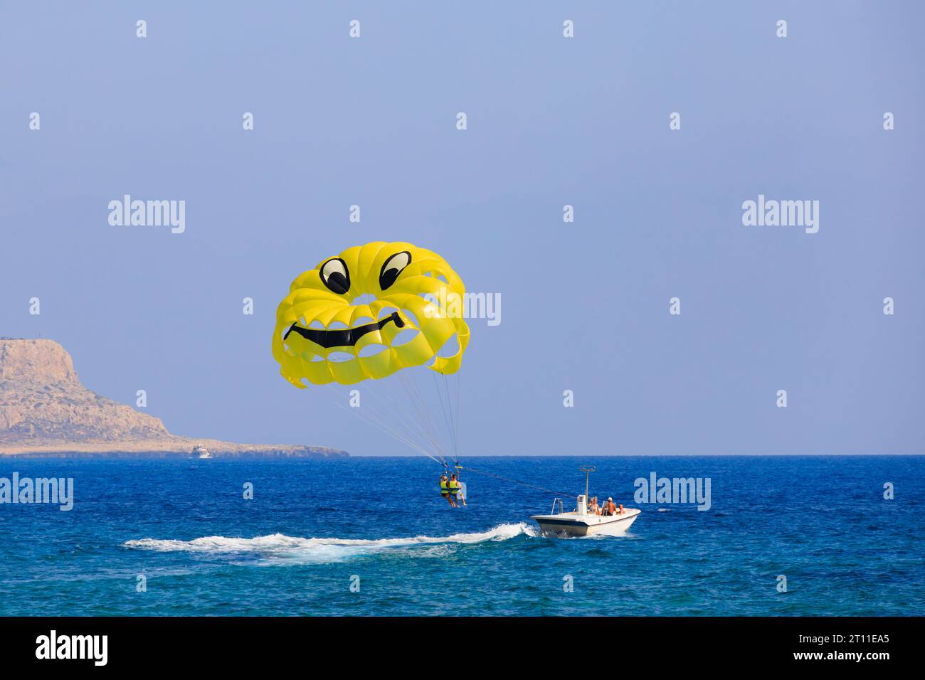 A man and woman tourists fly from a speedboat powered parascending ...