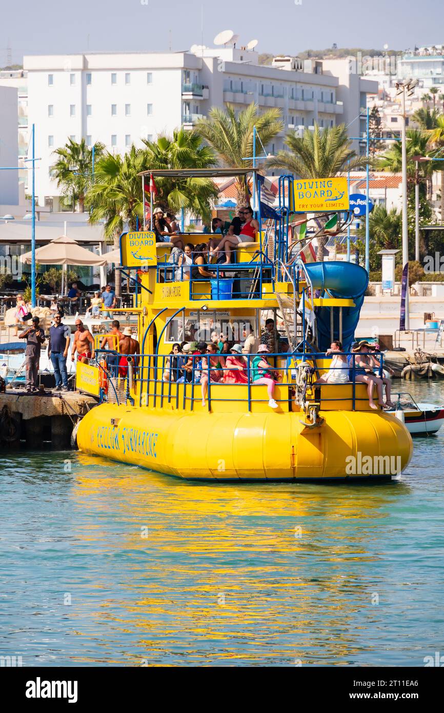 Tourists sit on the Yellow Submarine pleasure craft as it waits to ...