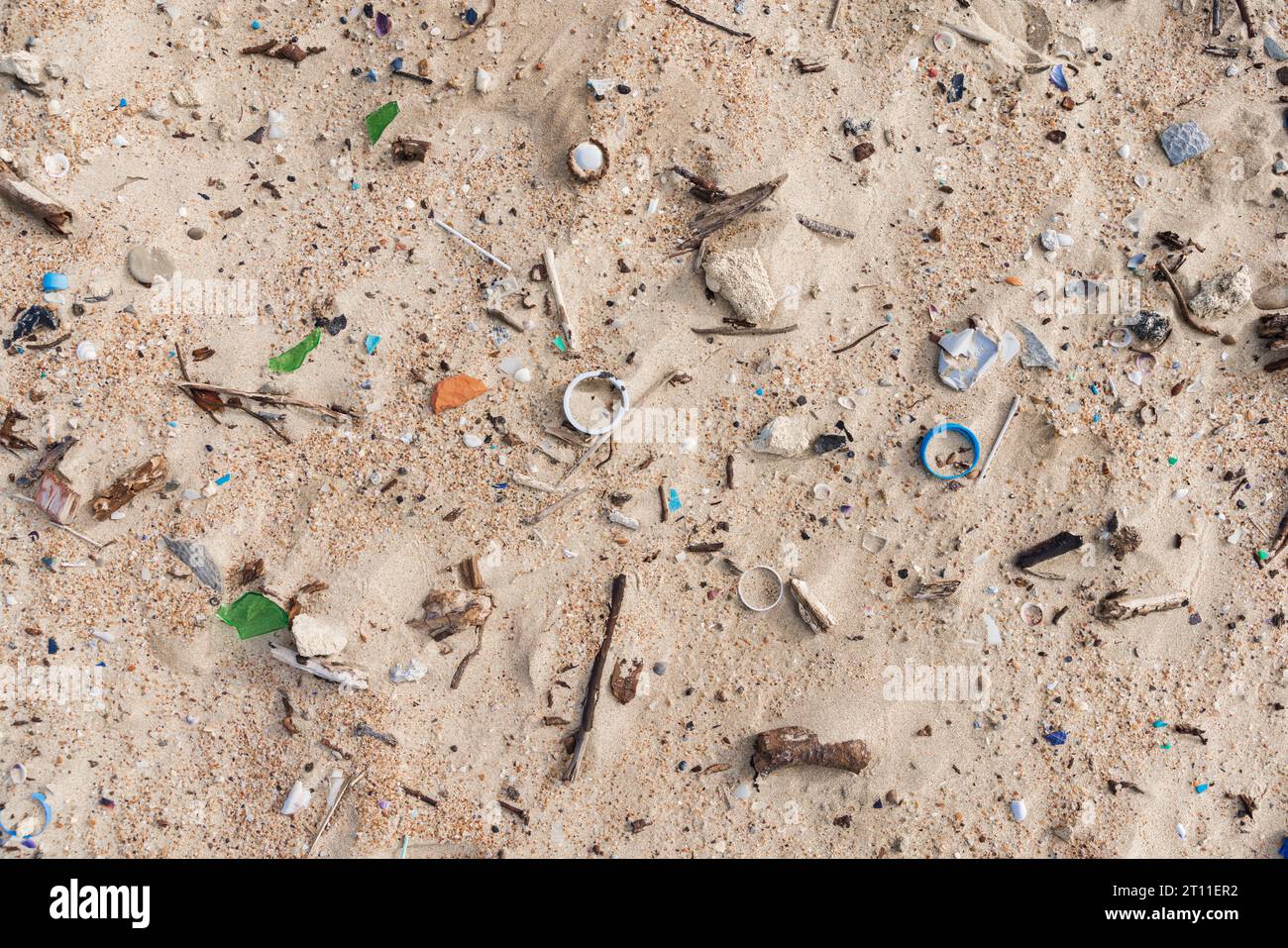 Plastic trash in sand on ocean beach. Pollution by microplastic rubbish ...