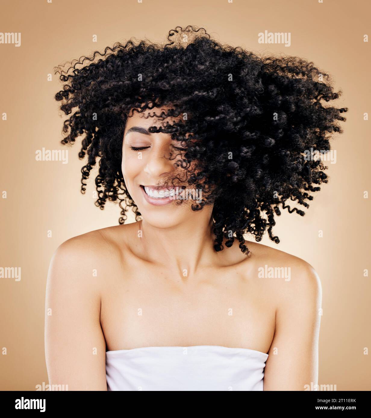 Woman, shake hair with curls and shine, smile for salon treatment or ...