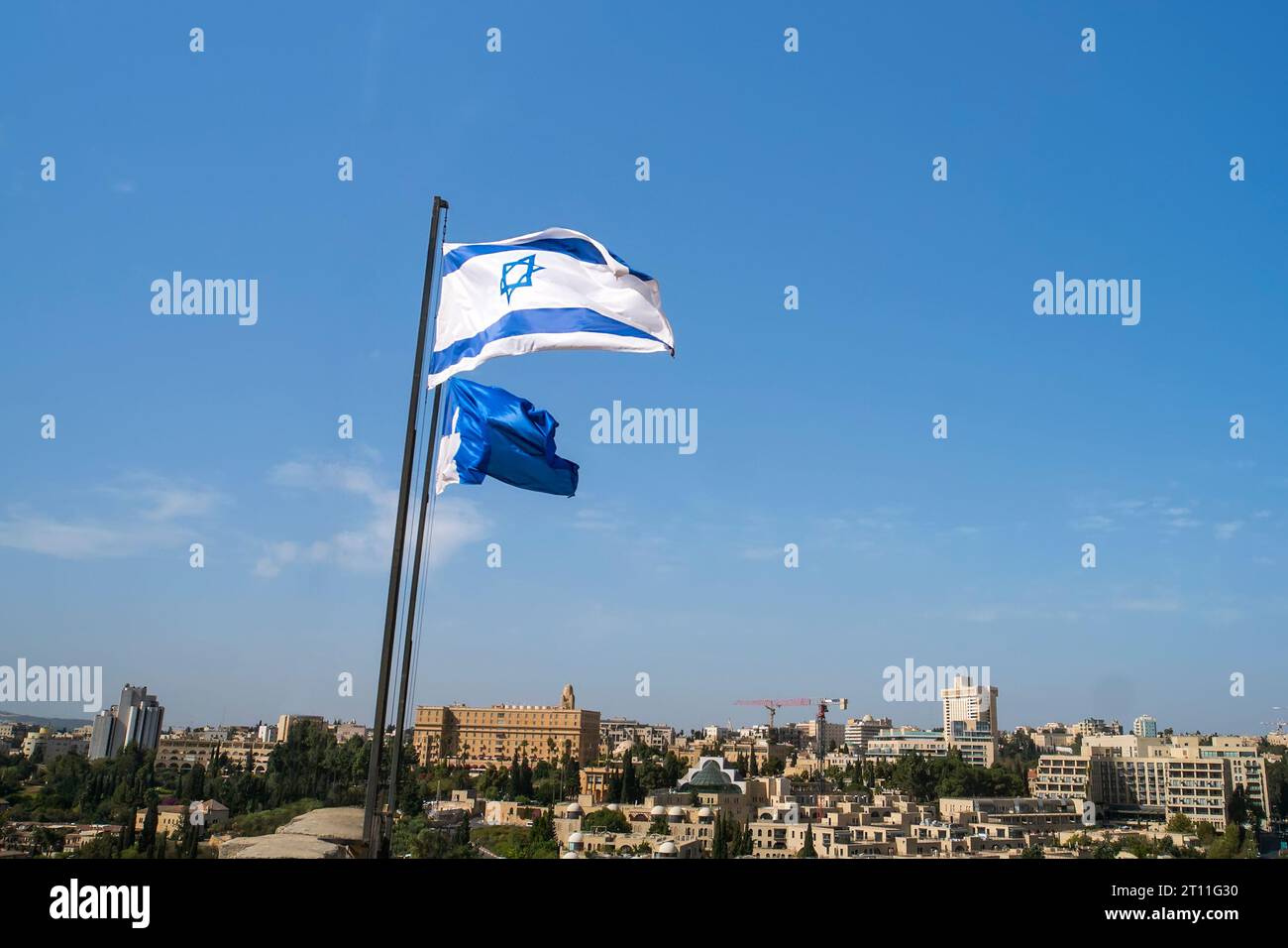 Israel and Jerusalem flags shot at blue cloudless sky background above ...