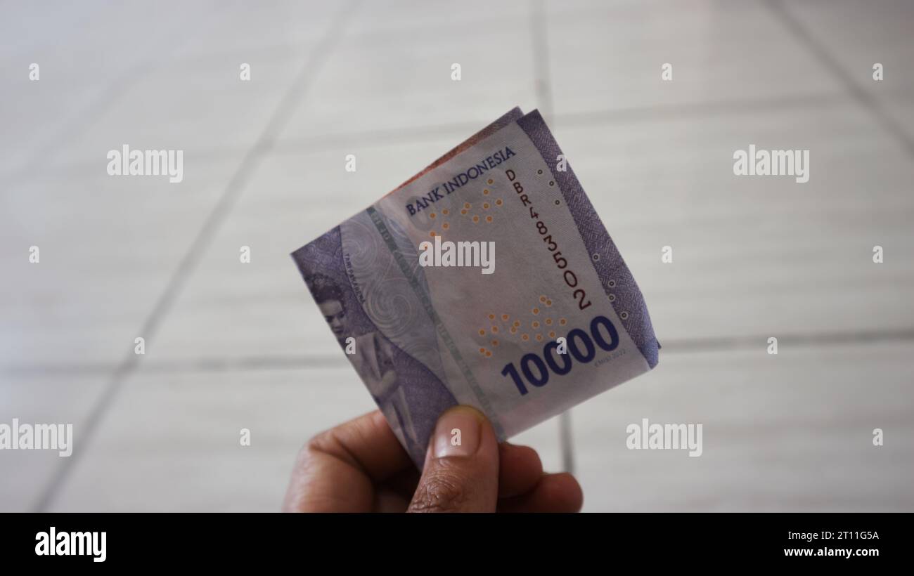 Batu City, East Java, Indonesia . October 20 ,2023 : man holding ...
