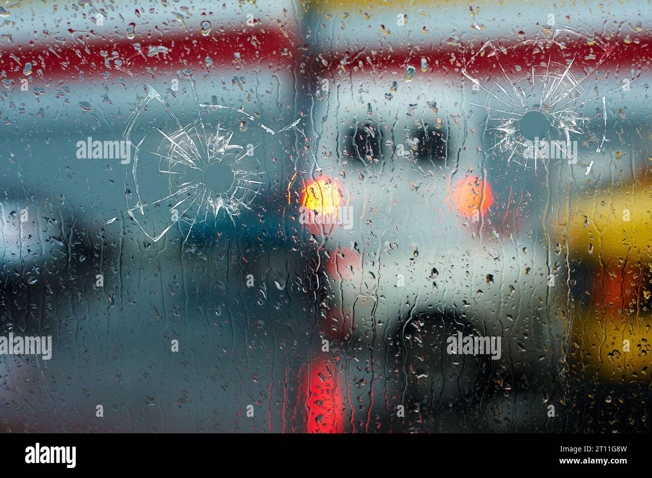 bullet holes in glass against the background of a blurred city close-up ...