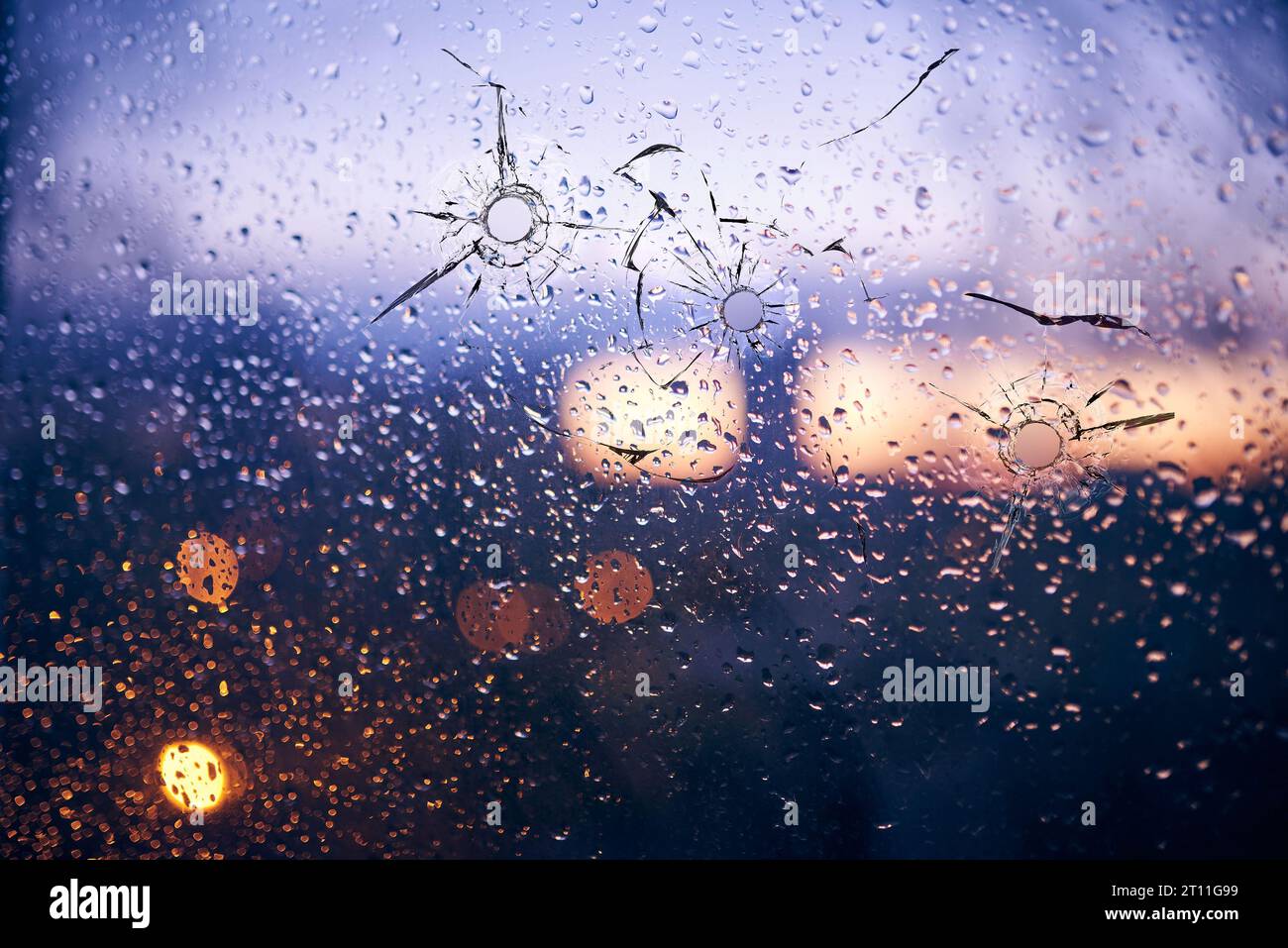 bullet holes in glass against the background of a blurred city close-up ...