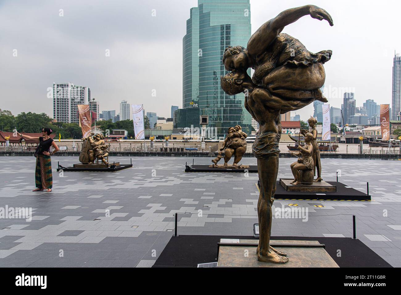 A visitor takes selfies next to sculptures created by Chinese artist Xu ...