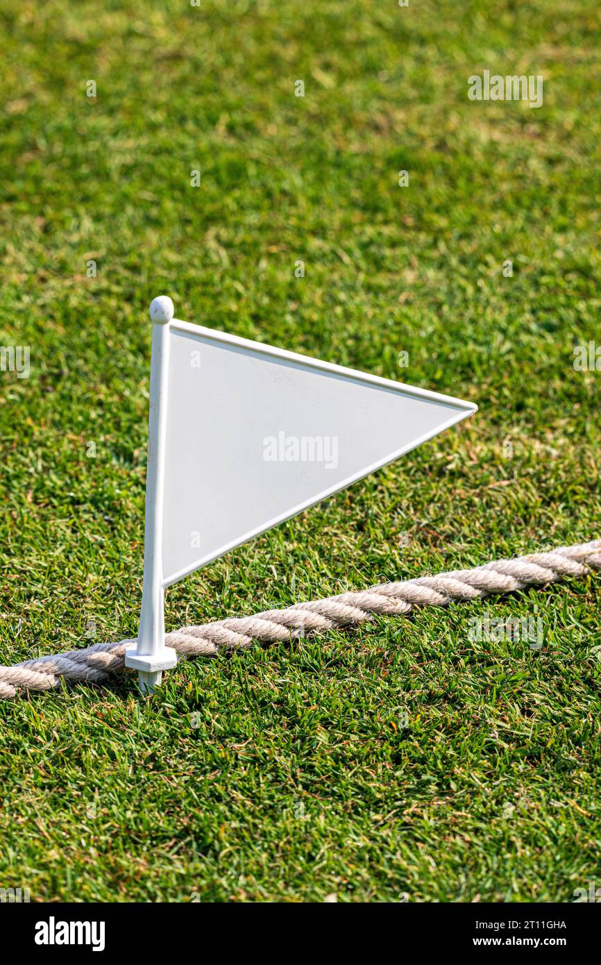 Traditional boundary rope and flag on a grass cricket pitch Stock Photo ...