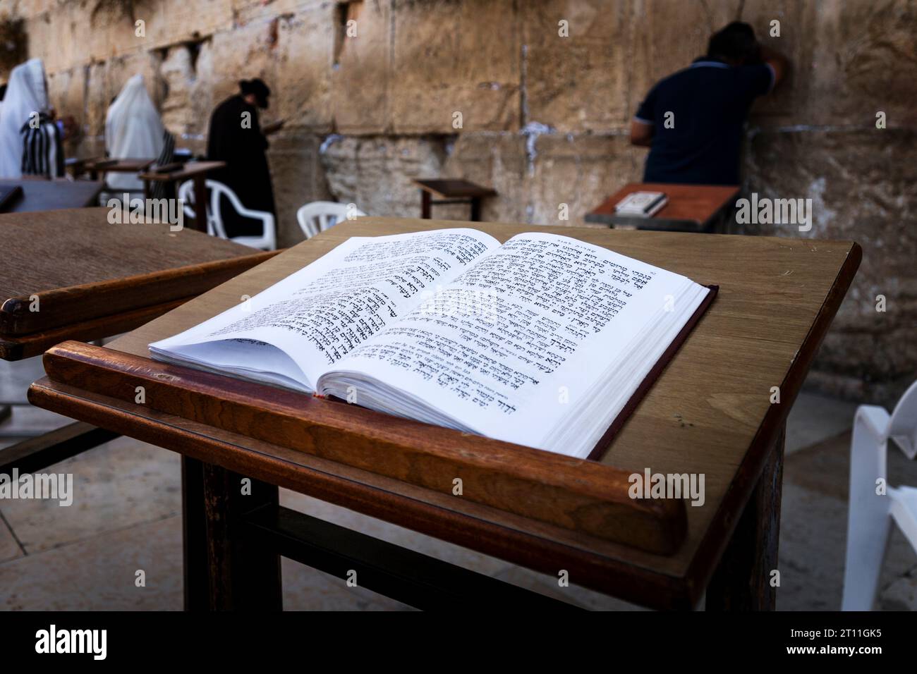 Jewish bible - Torrah on table on blurred background of praying Jews ...