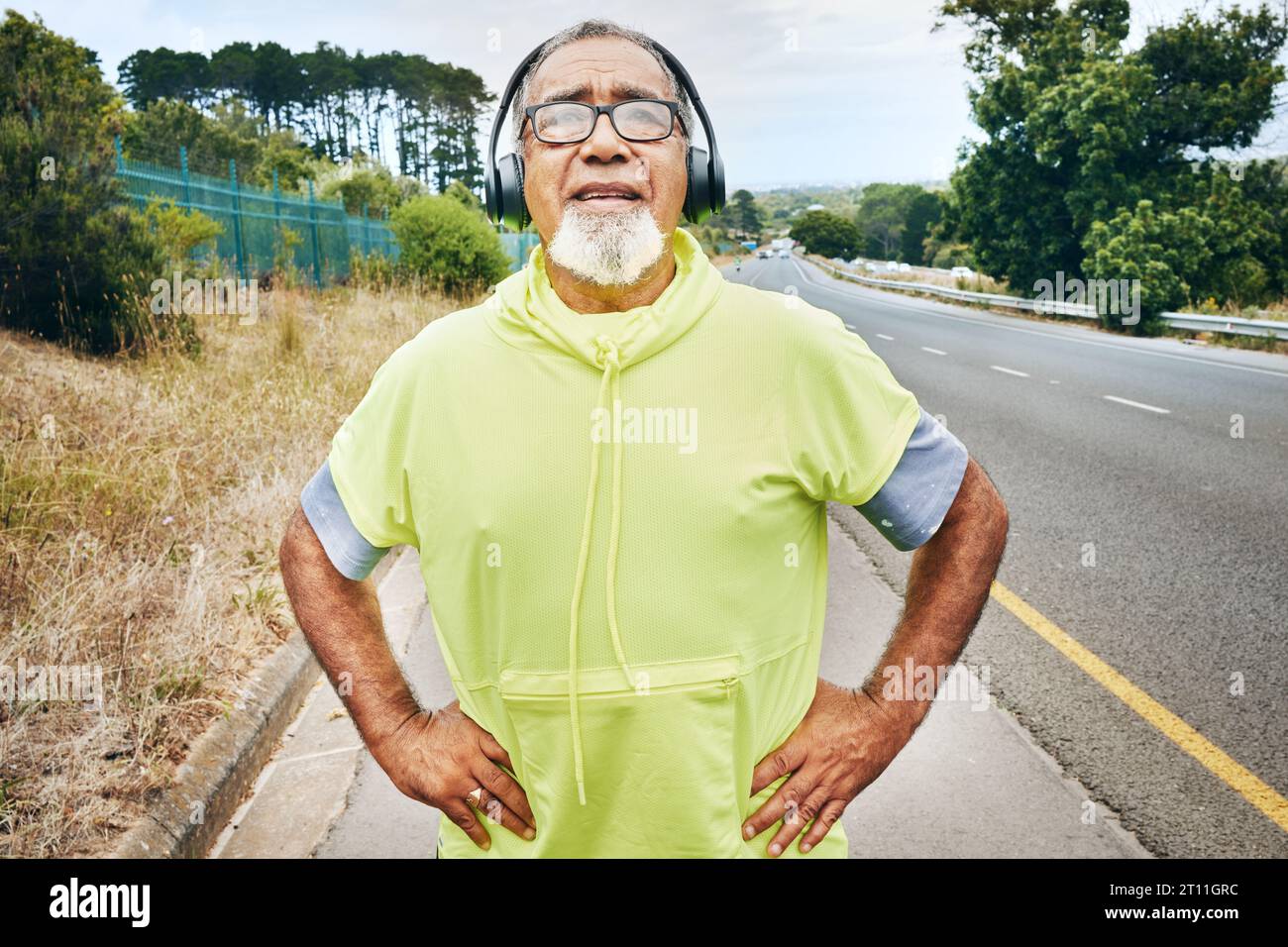 Outdoor, tired and senior man with fitness, headphones and fatigue with ...