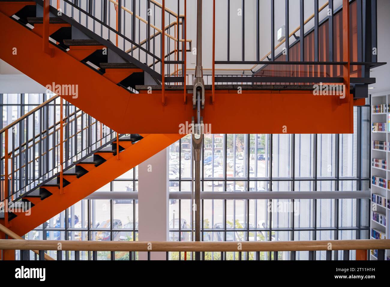 A side view of a steel staircase painted in intense colors. It looks ...