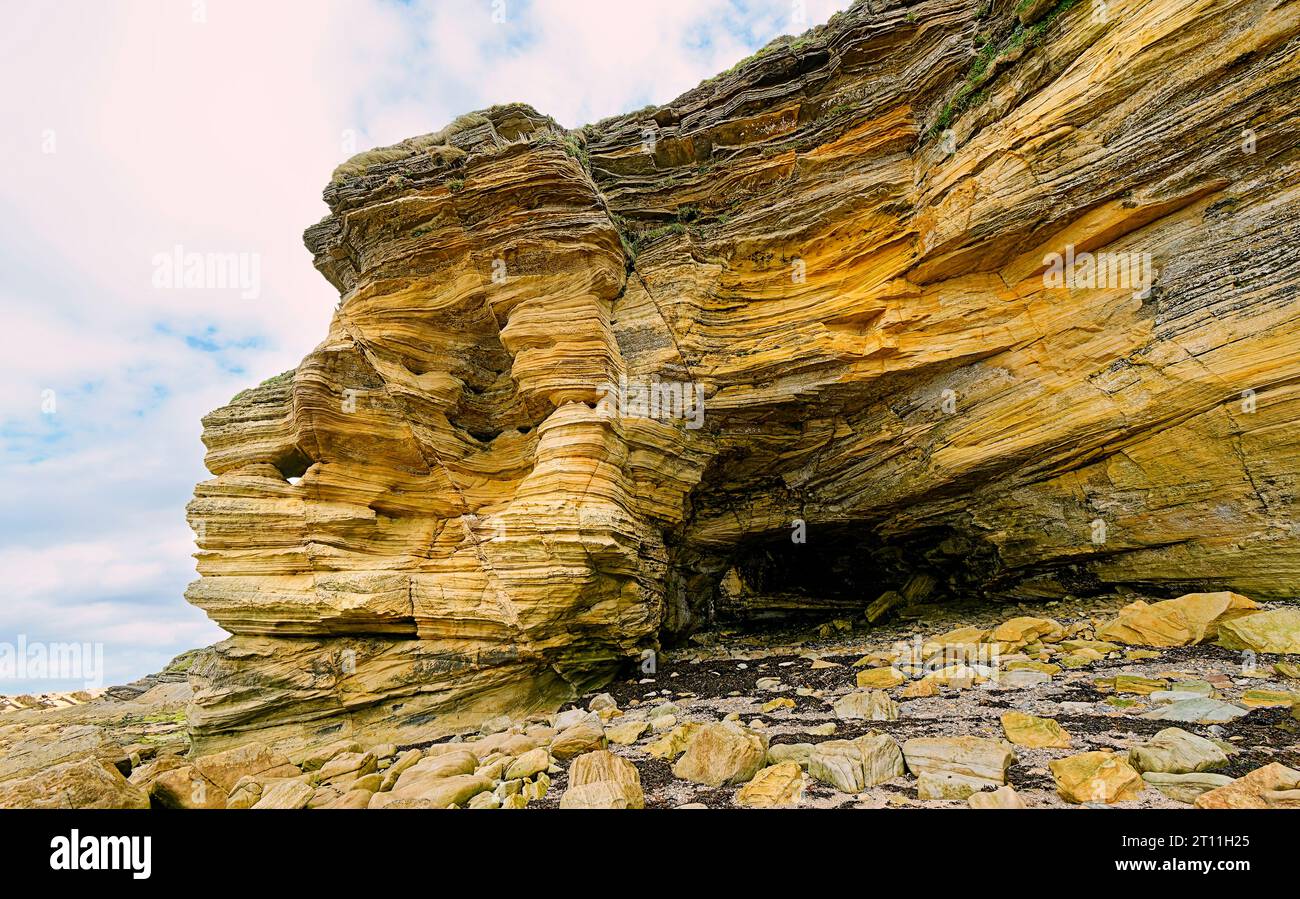 Hopeman Moray Coast Scotland dark cave entrance to golden coloured ...