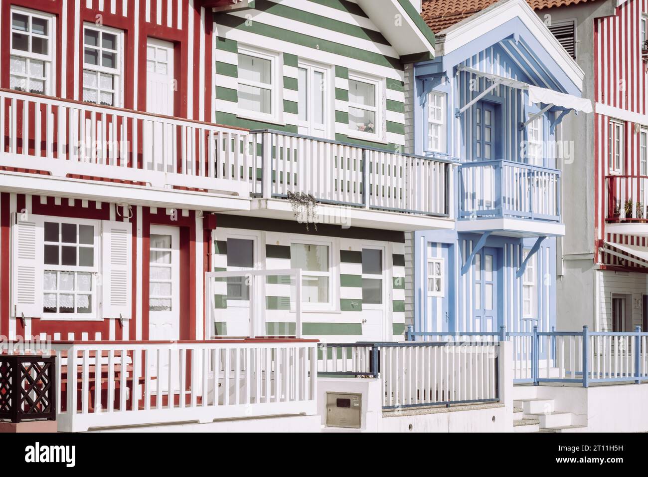 View of a row of colorful houses in Costa Nova, a picturesque beach ...
