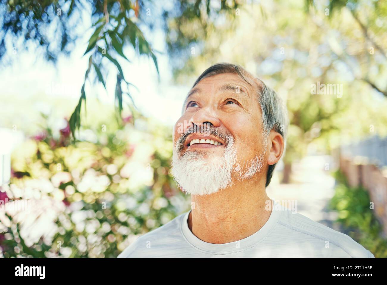 Smile, calm and senior man in nature breathing for fresh air, peaceful ...