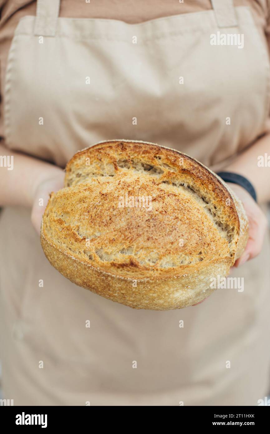Female hands holding bread Stock Photo - Alamy