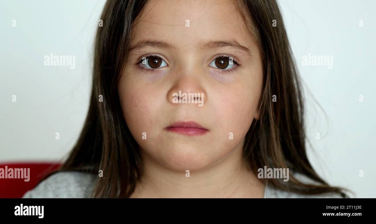 Portrait sad little girl child face close-up looking at camera Stock Photo - Alamy