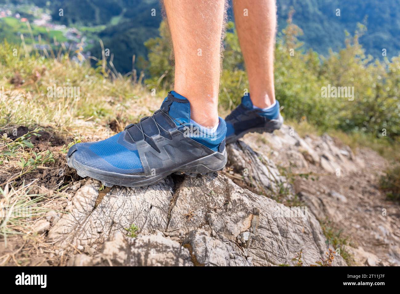 Legs in motion, shins, and feet in sneakers, a male hiker walking ...