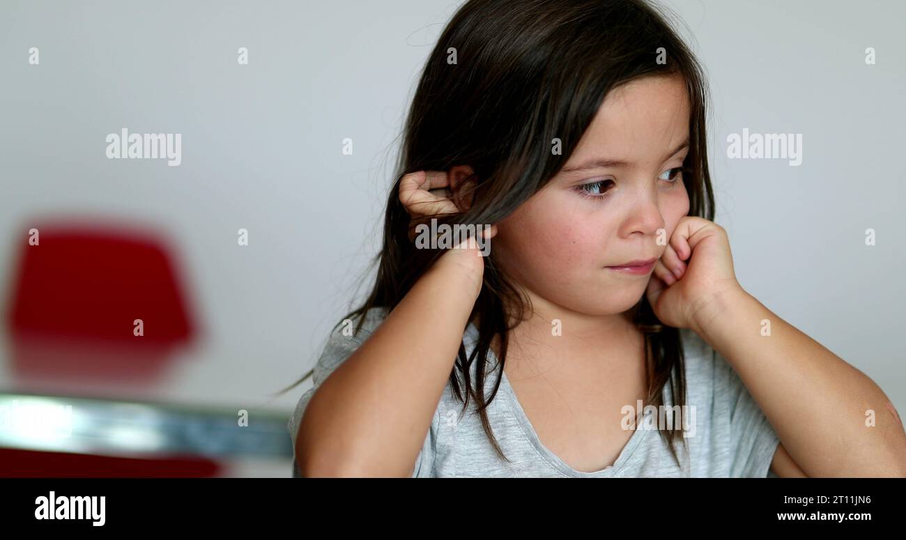 Tired little girl rubbing eyes with hands Stock Photo - Alamy