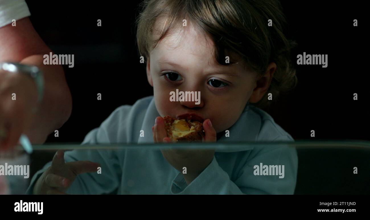 Toddler grabbing cookie. Baby boy grabs food from table Stock Photo - Alamy