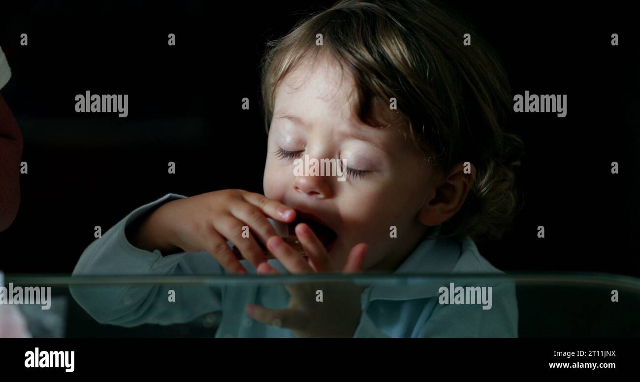 Toddler grabbing cookie. Baby boy grabs food from table Stock Photo - Alamy