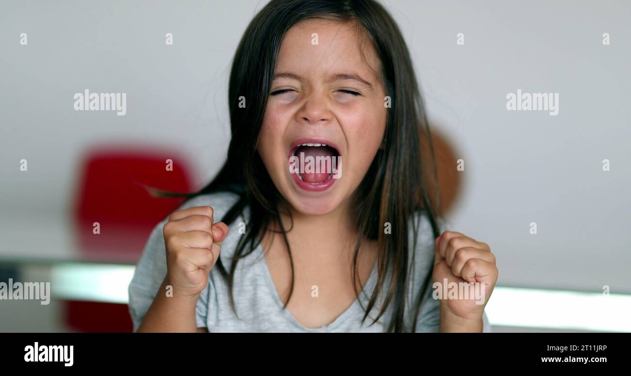 Upset little girl yelling feeling angry Stock Photo - Alamy