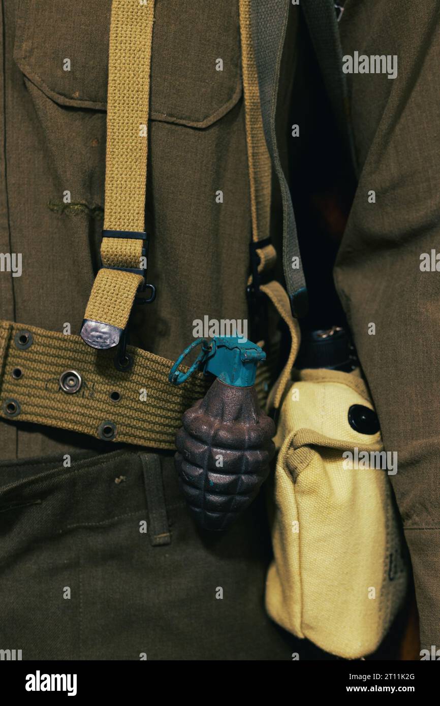 Close up of canteen and hand grenade strapped to soldier's belt Stock ...
