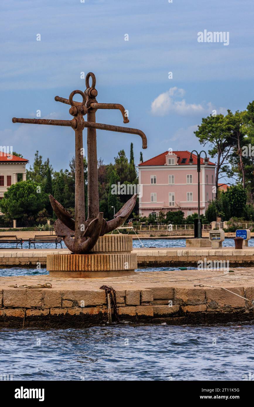 a statue of two upright admiralty pattern anchors stands on the pier of ...
