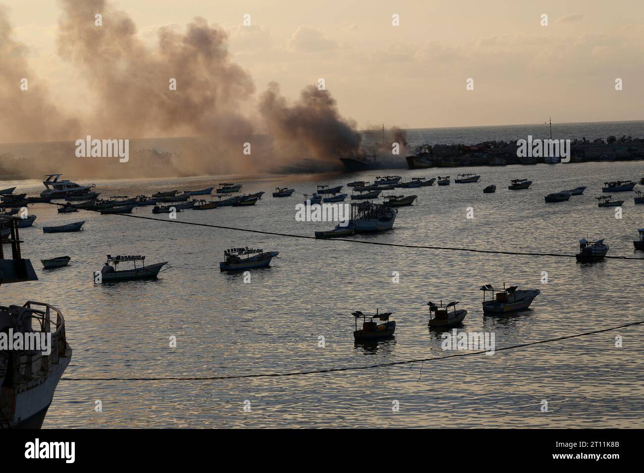 Smoke rises from burning fishing boats caused by an Israeli airstrike ...