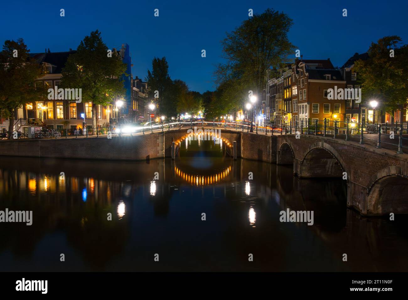 Netherlands. Night canal in Amsterdam. Facades of typical buildings on ...