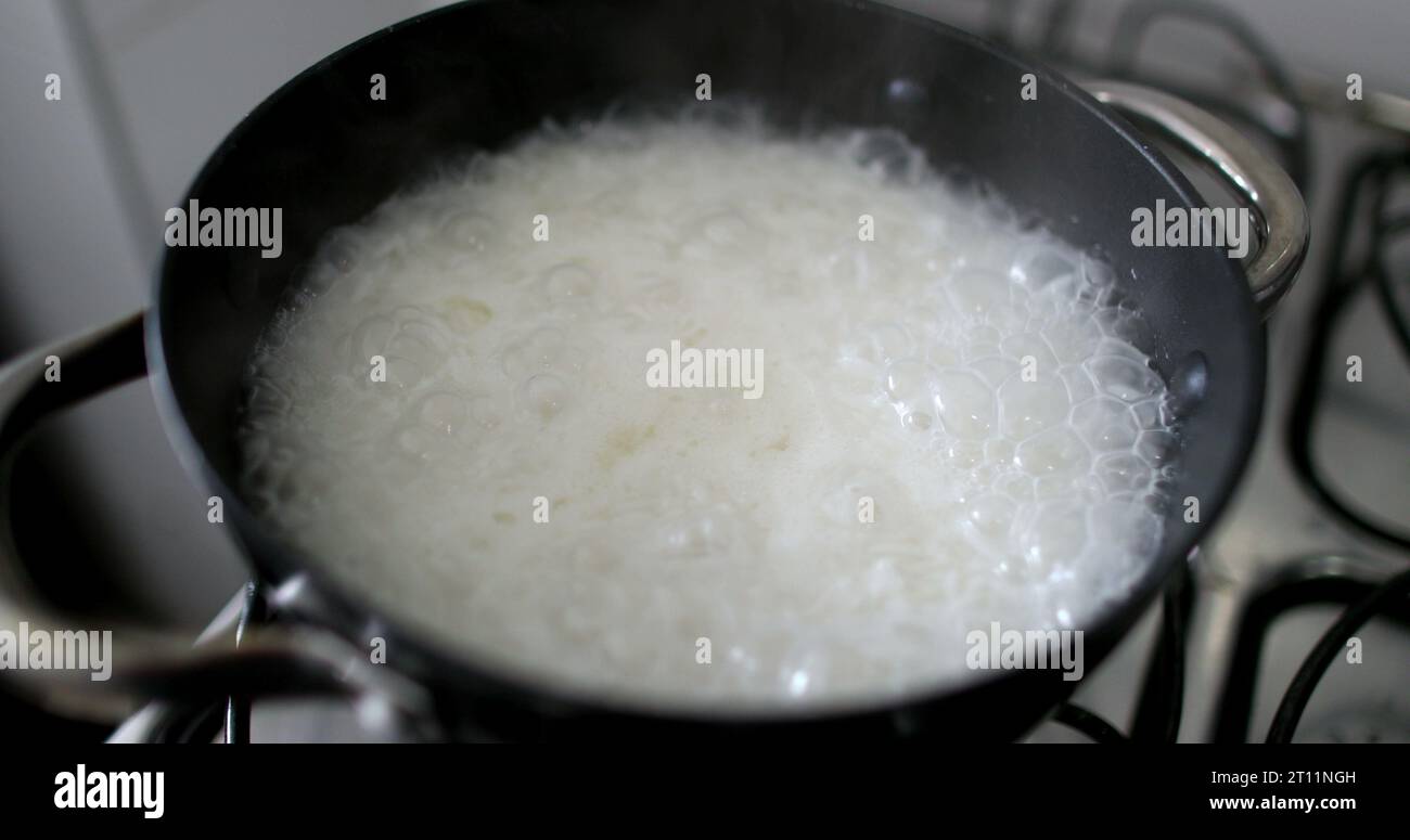 Cooking boiling water inside pan Stock Photo - Alamy