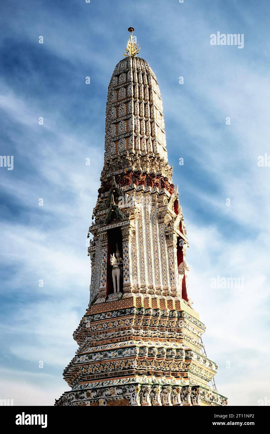 A temple in Thailand. The temple is a tall, ornate structure with many ...