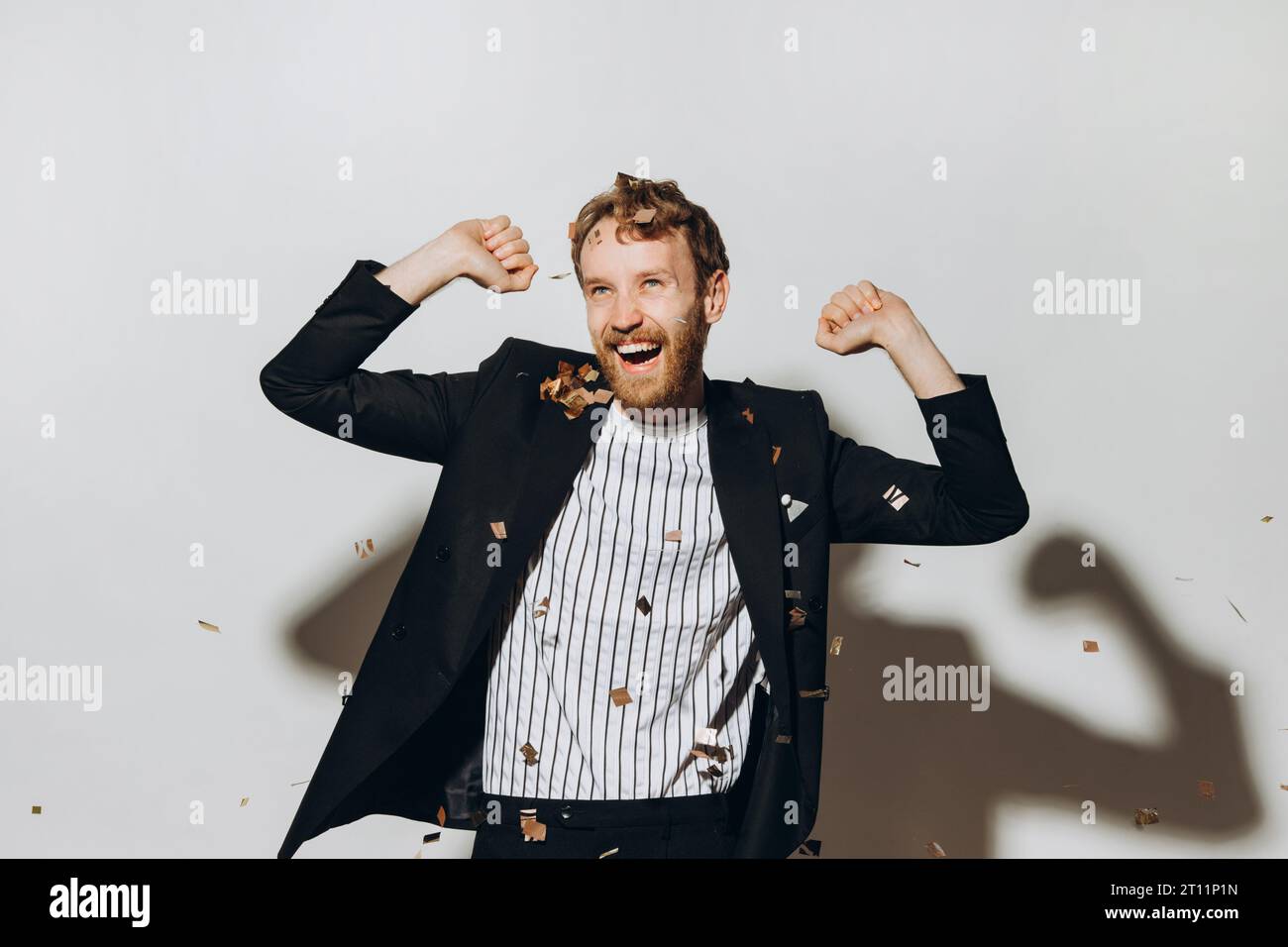 Concept of celebration and victory. Stylish young man isolated on white ...