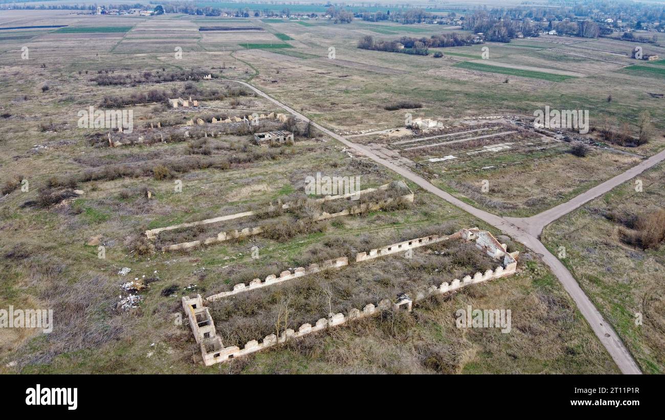 Destroyed agricultural buildings, aerial view. Abandoned livestock farm ...